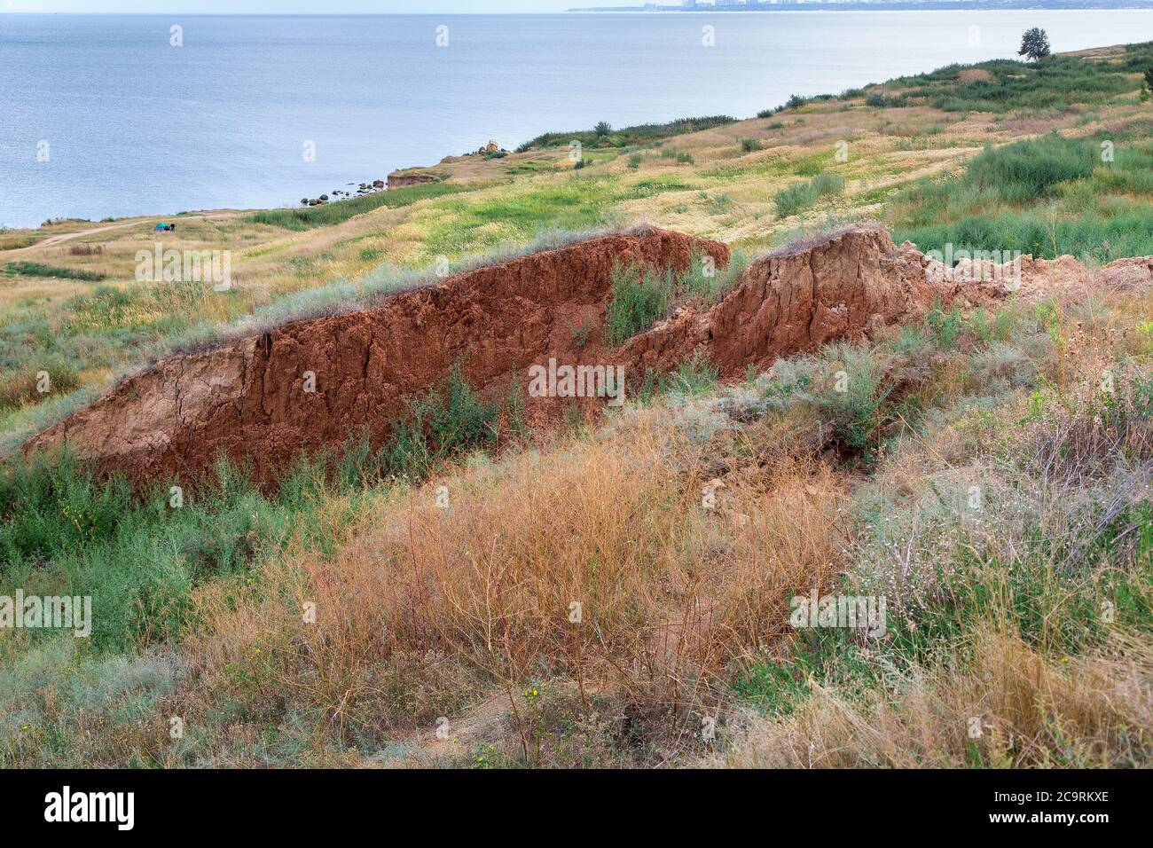 landslide in an environmentally hazardous area slopes on the coast, a ...