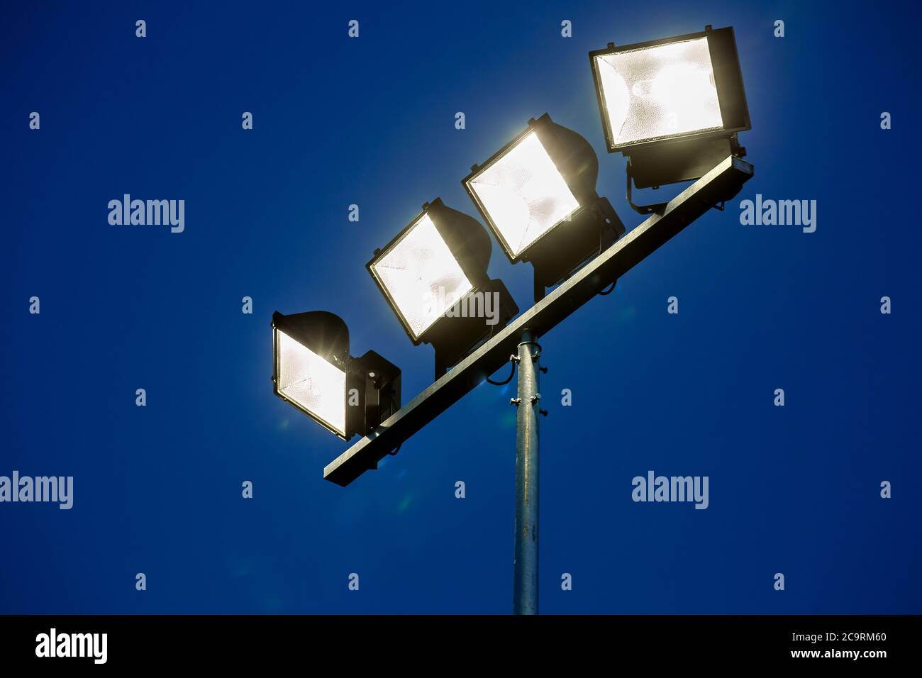 halogen spotlight on a column against the background of the sky, street ...