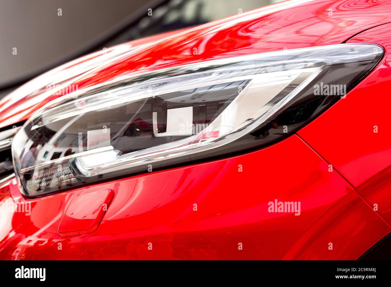 Car headlight close up, side view lens led light on the red car Stock ...