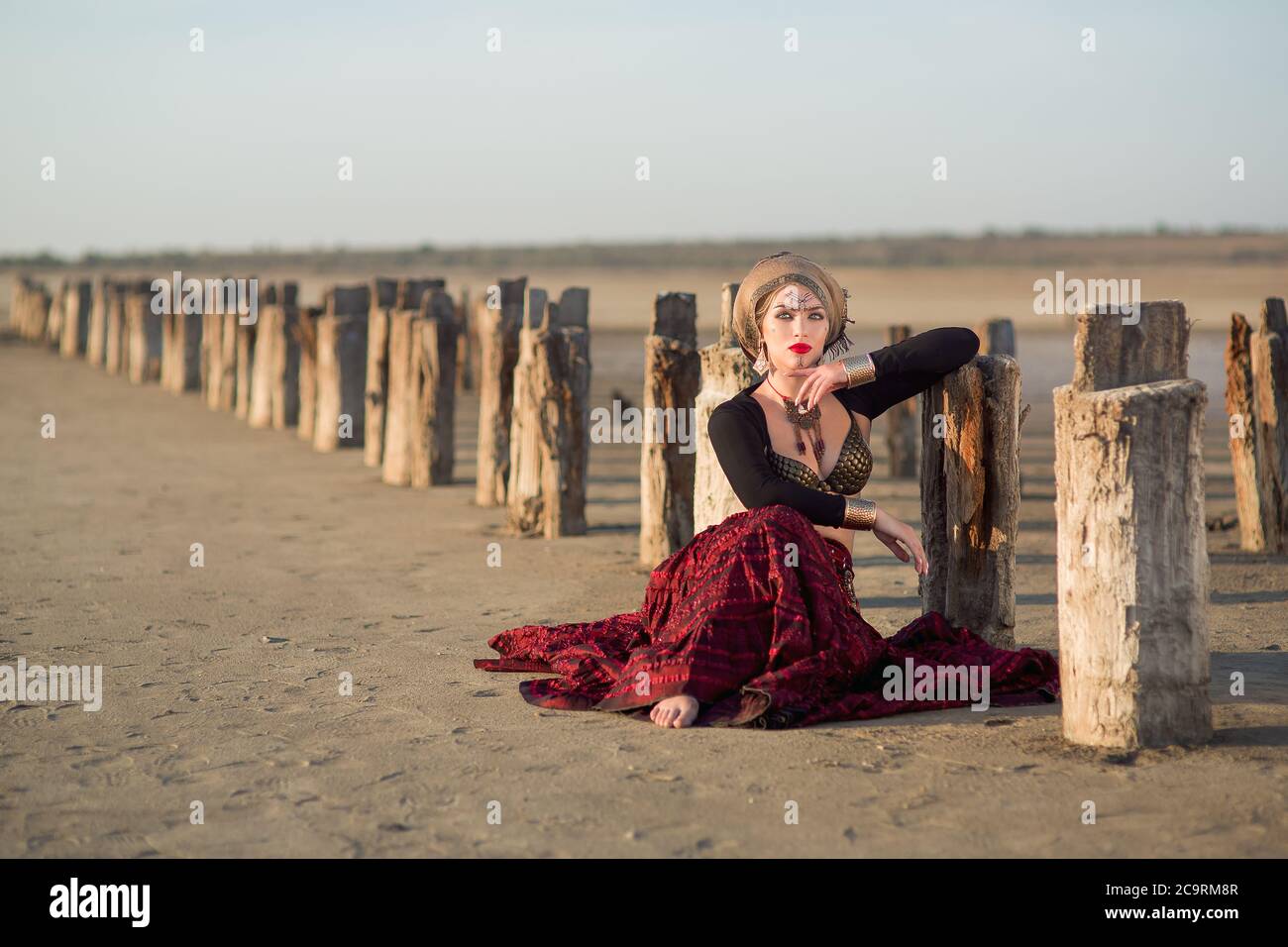 the girl of the dancer sits on the earth and leans the elbows on the ...