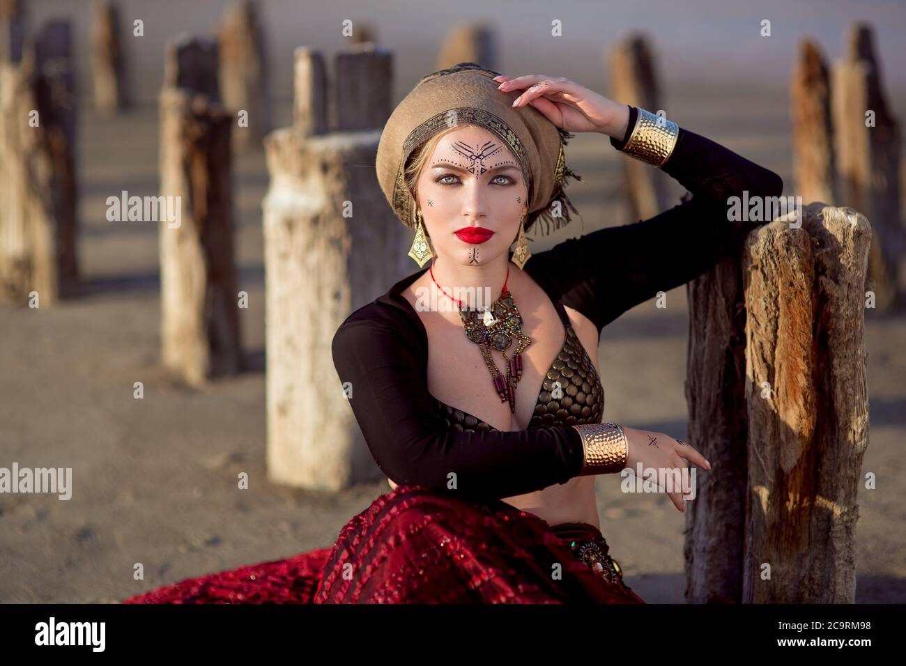 the girl portrait of the dancer sits on the earth and leans the elbows ...