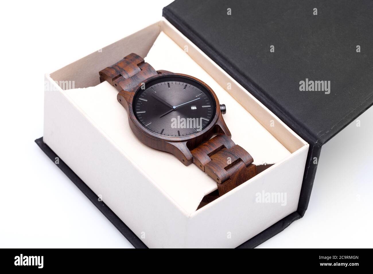 brown wooden wrist watch packed in open a box top side view, on a white ...