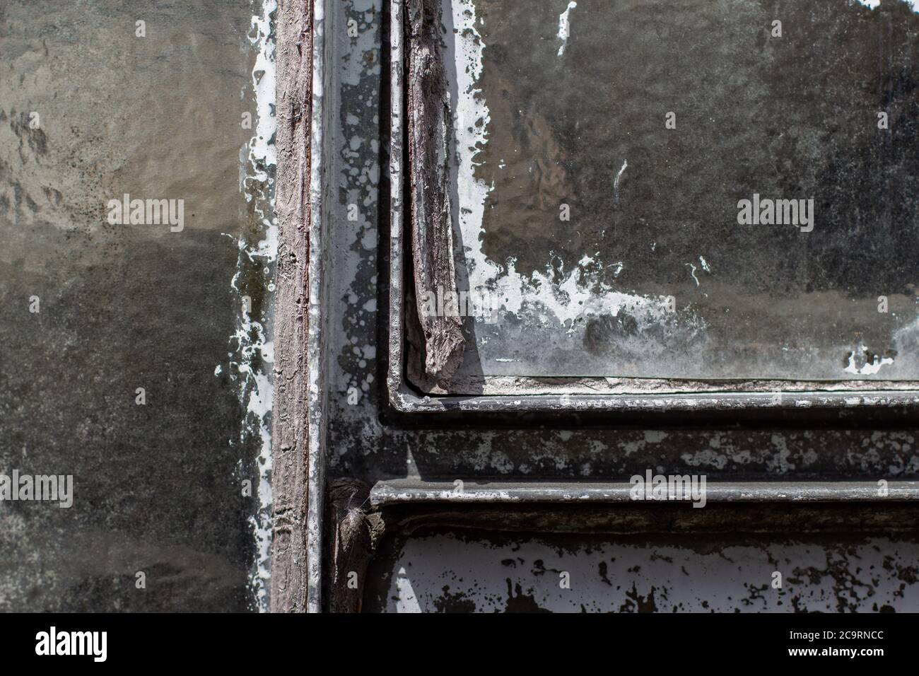 Old, dry and cracked window sealing peeling off between the glass and ...