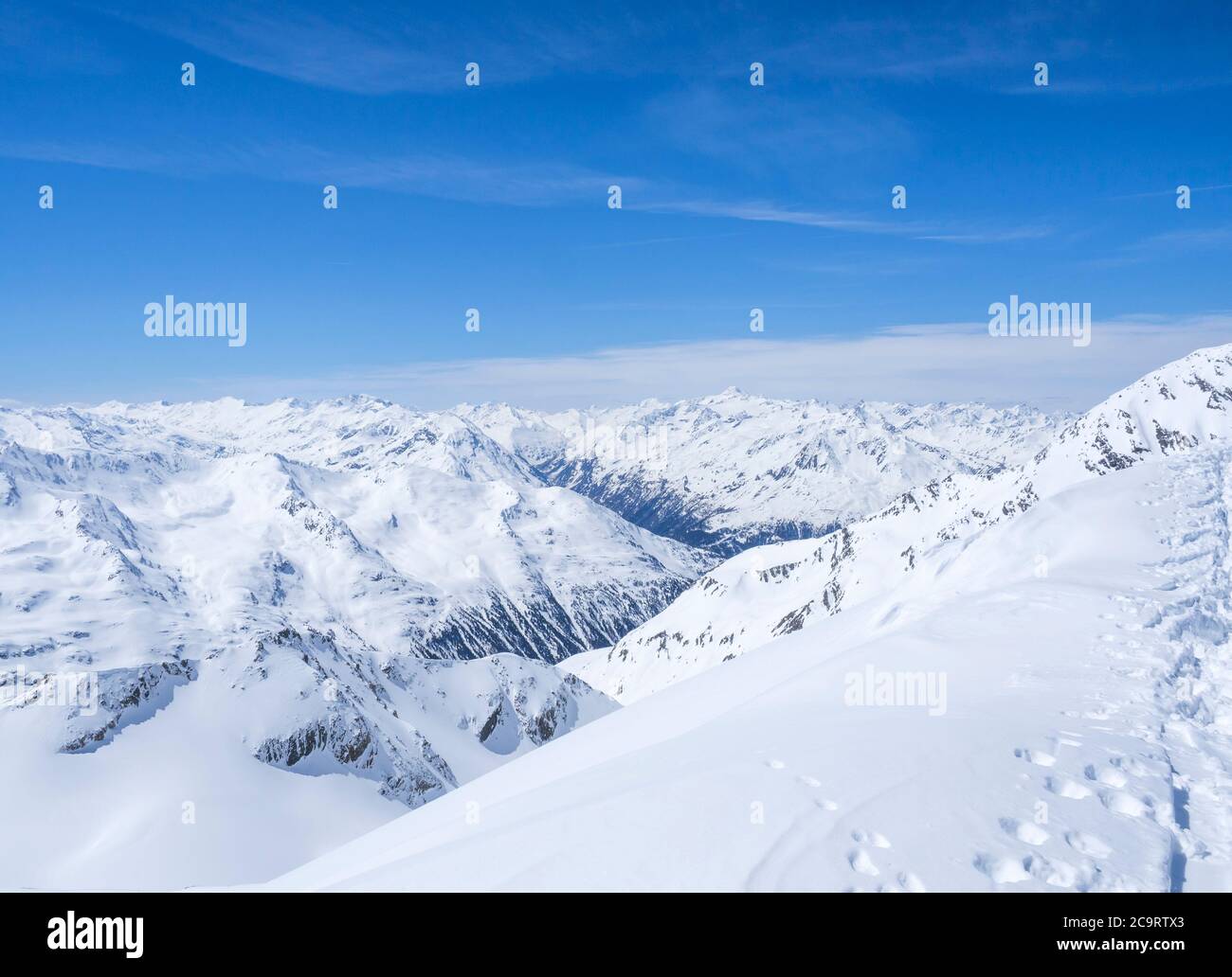 Winter landscape with snow covered slopes and blue sky, view from the ...