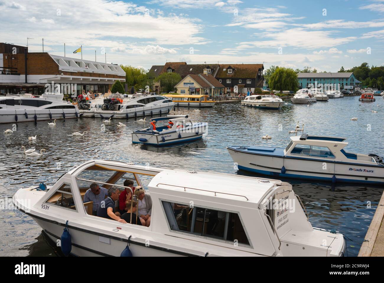 Norfolk Broads, view from Wroxham quay of people hiring small pleasure ...