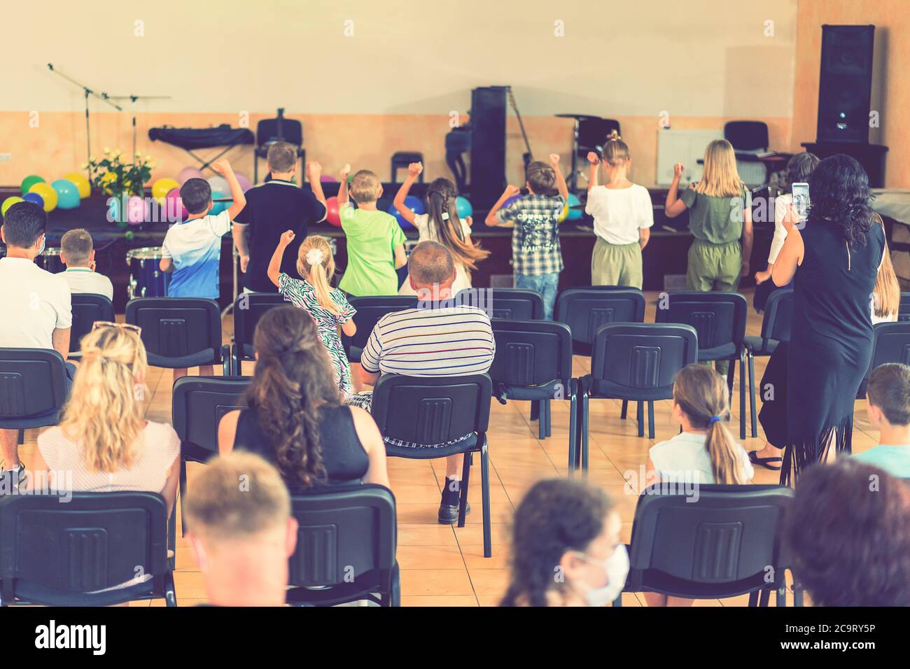 Children's holiday in elementary School. Children on stage perform in ...
