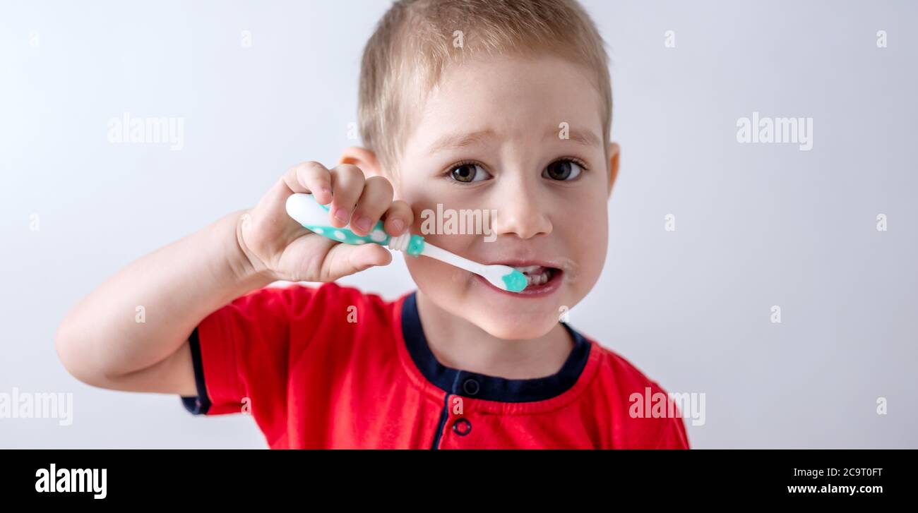A little boy is learning to brush his teeth using a toothbrush. Concept ...