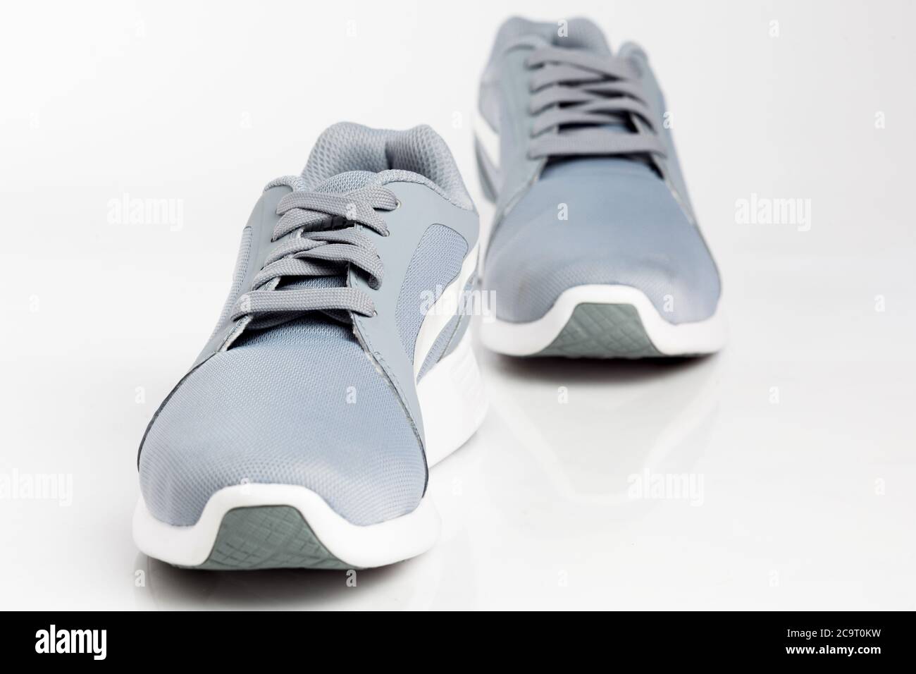 Grey sports running shoes isolated on white background. Light runners ...