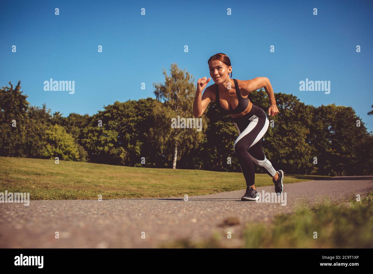 beautiful girl running in the city park Stock Photo - Alamy