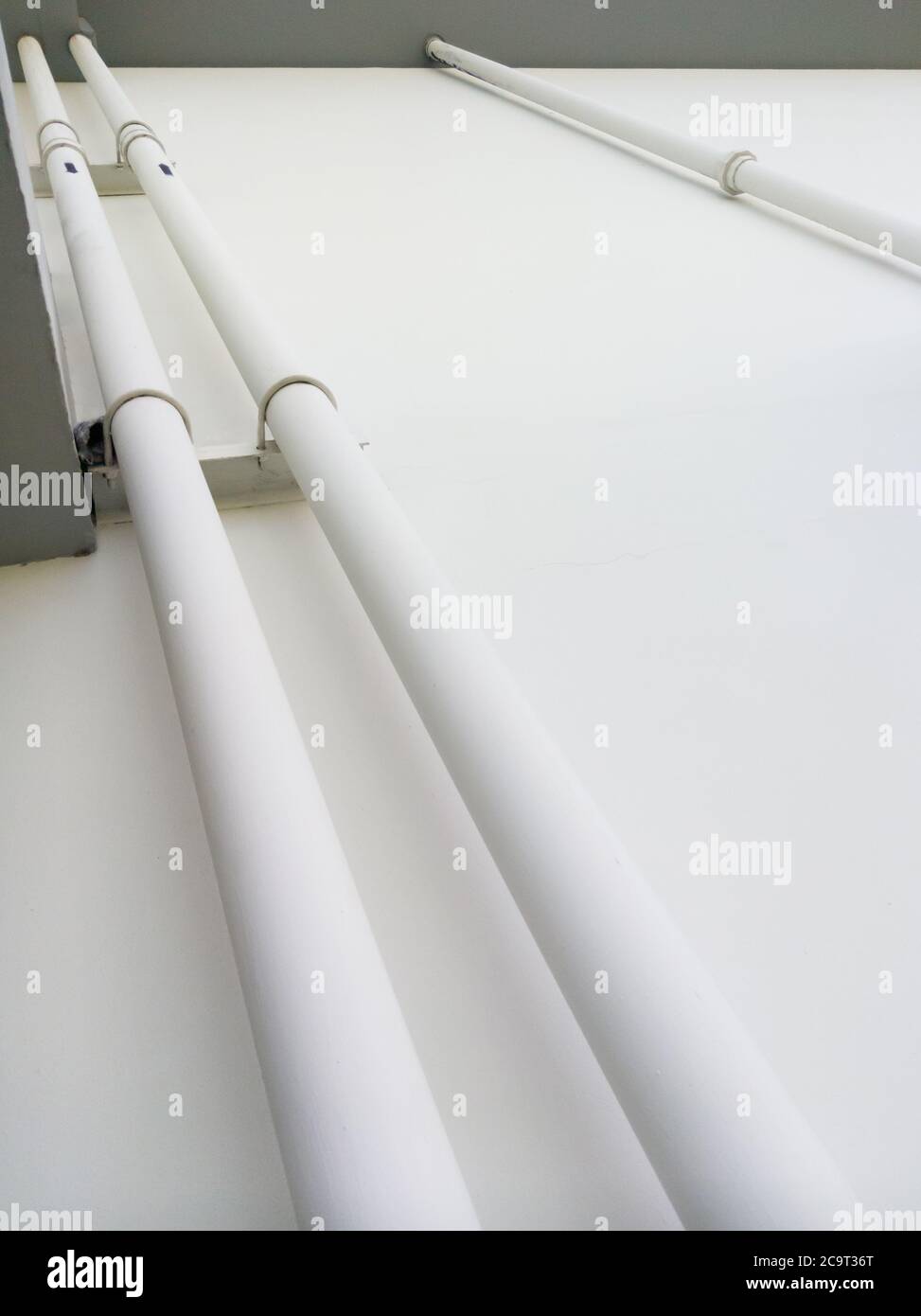 White pipe row on the concrete wall for the cold water system to use in ...
