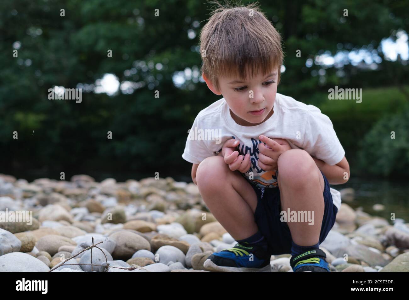 Child playing with rocks hi-res stock photography and images - Alamy