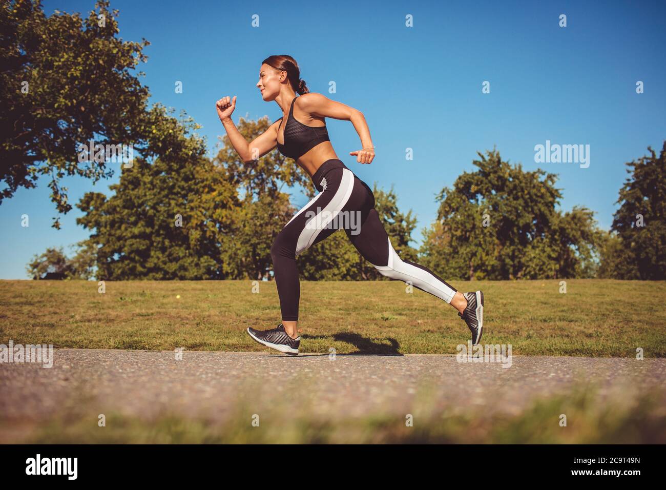 beautiful girl running in the city park Stock Photo - Alamy