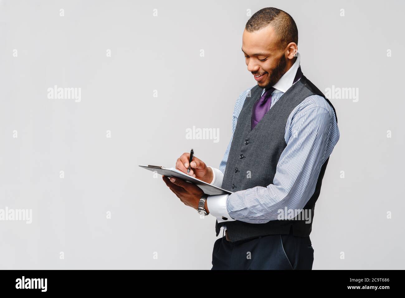 a young african american man holding plain table tablet and pen Stock ...