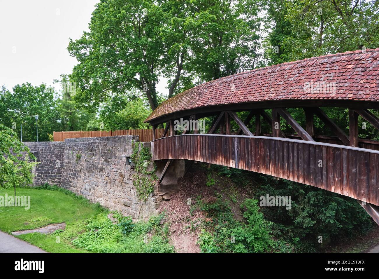 Medieval covered wooden bridge over the city moat in Rothenburg Stock ...