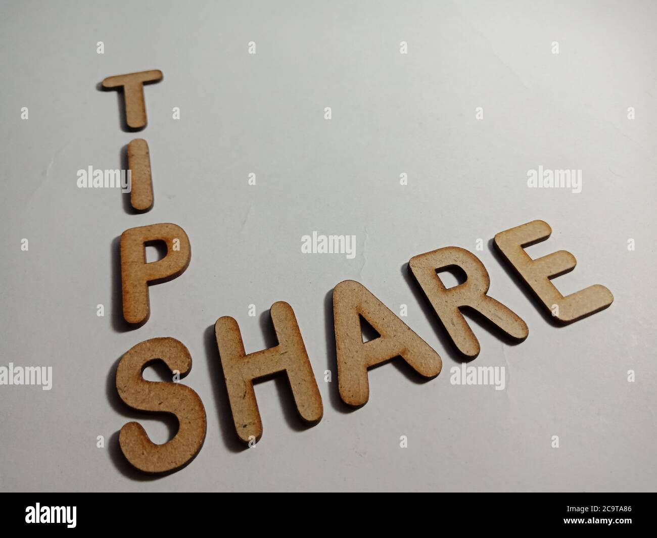 Share tips word presented on white surface with wooden cross text cloud ...