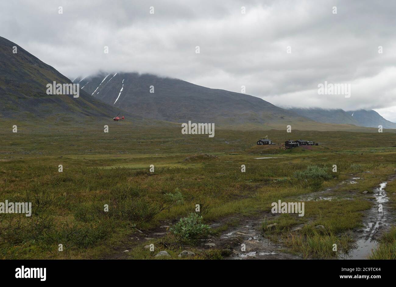 Red helicopter supply Hikers at Mountain Lodge Salka STF hut. Lapland ...