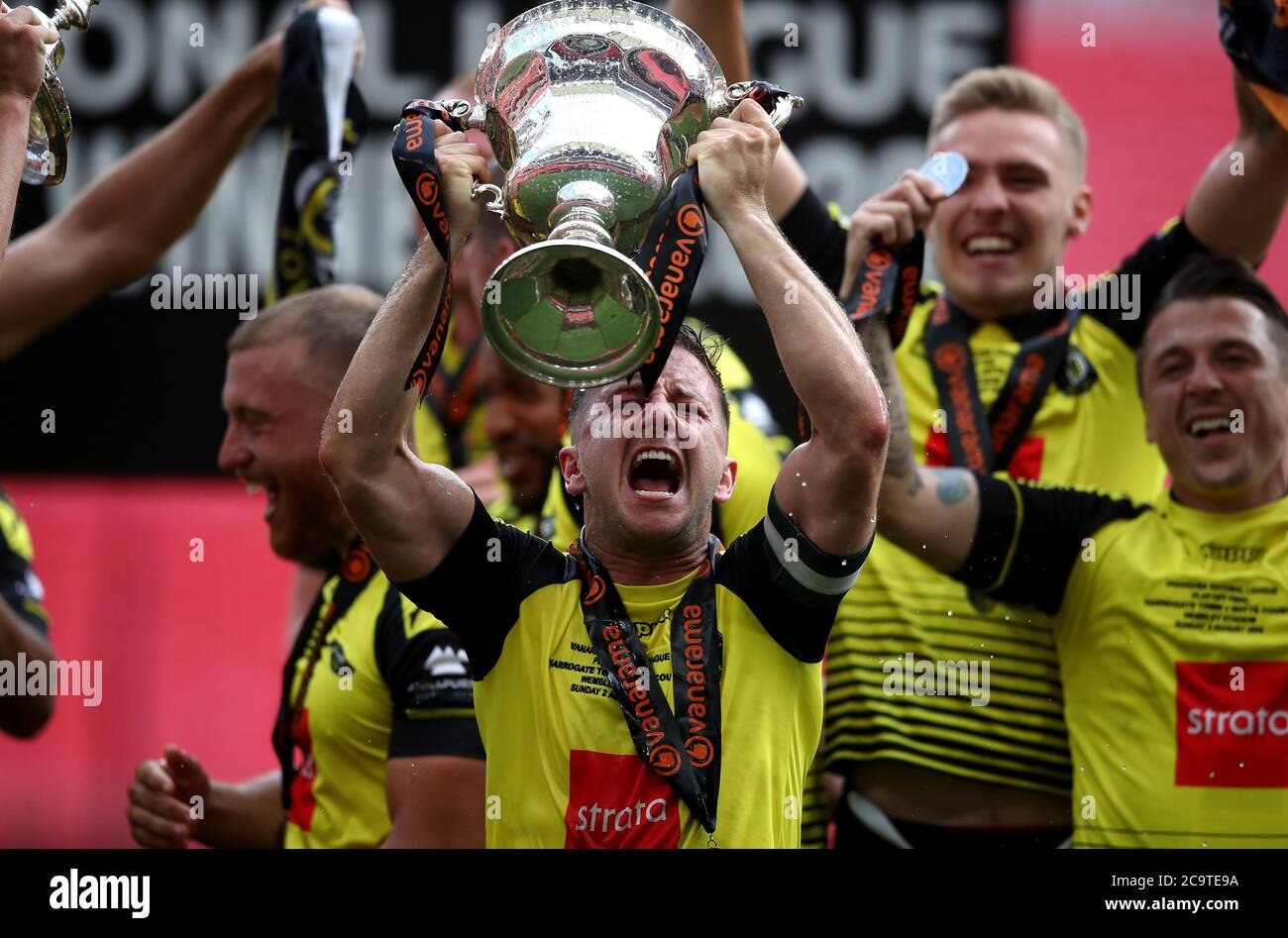 Harrogate Town's Josh Falkingham lifts the trophy after the final ...