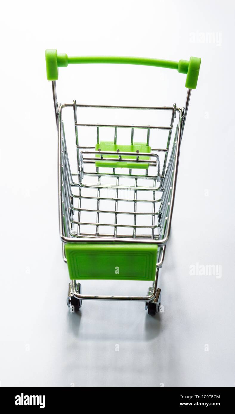 Shopping cart or shopping trolley in green isolated on white background ...