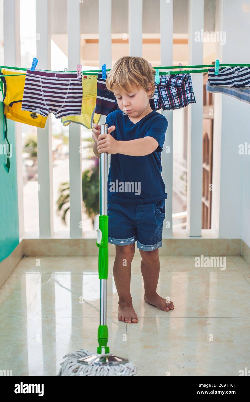 kid boy cleaning room, washing floor with mop. Little home helper Stock ...