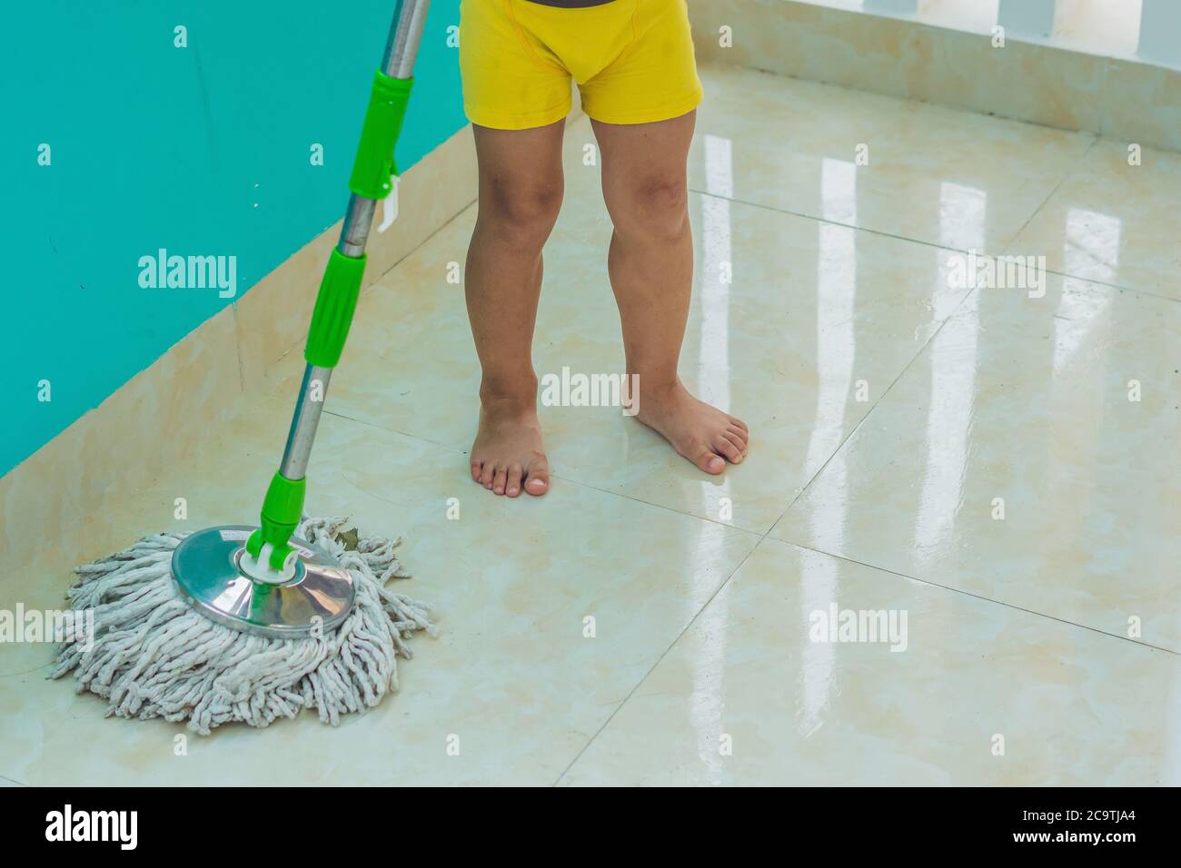 kid boy cleaning room, washing floor with mop. Little home helper Stock ...