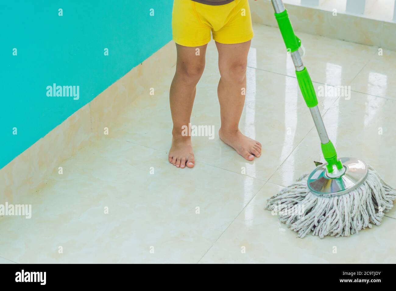 kid boy cleaning room, washing floor with mop. Little home helper Stock ...