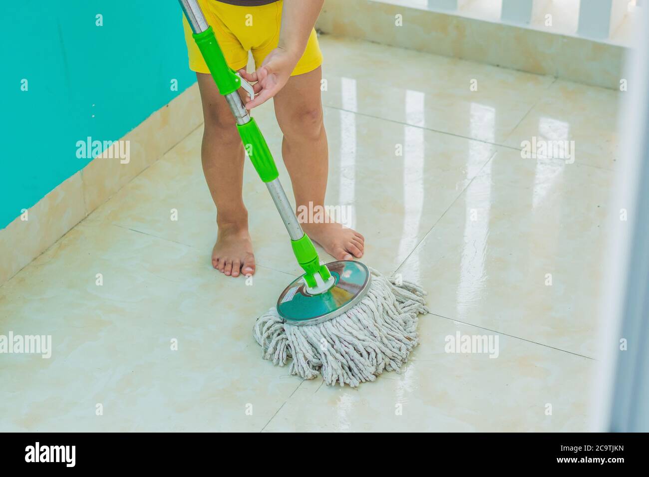kid boy cleaning room, washing floor with mop. Little home helper Stock ...