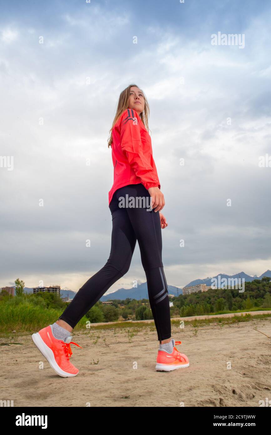 Fitness woman runner relaxing after city running and working out ...