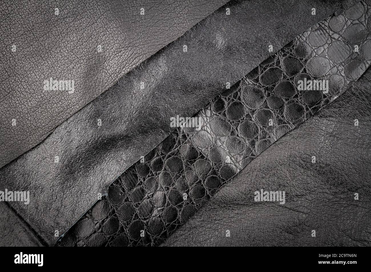Black leather and fake artificial alligator skin textures background ...