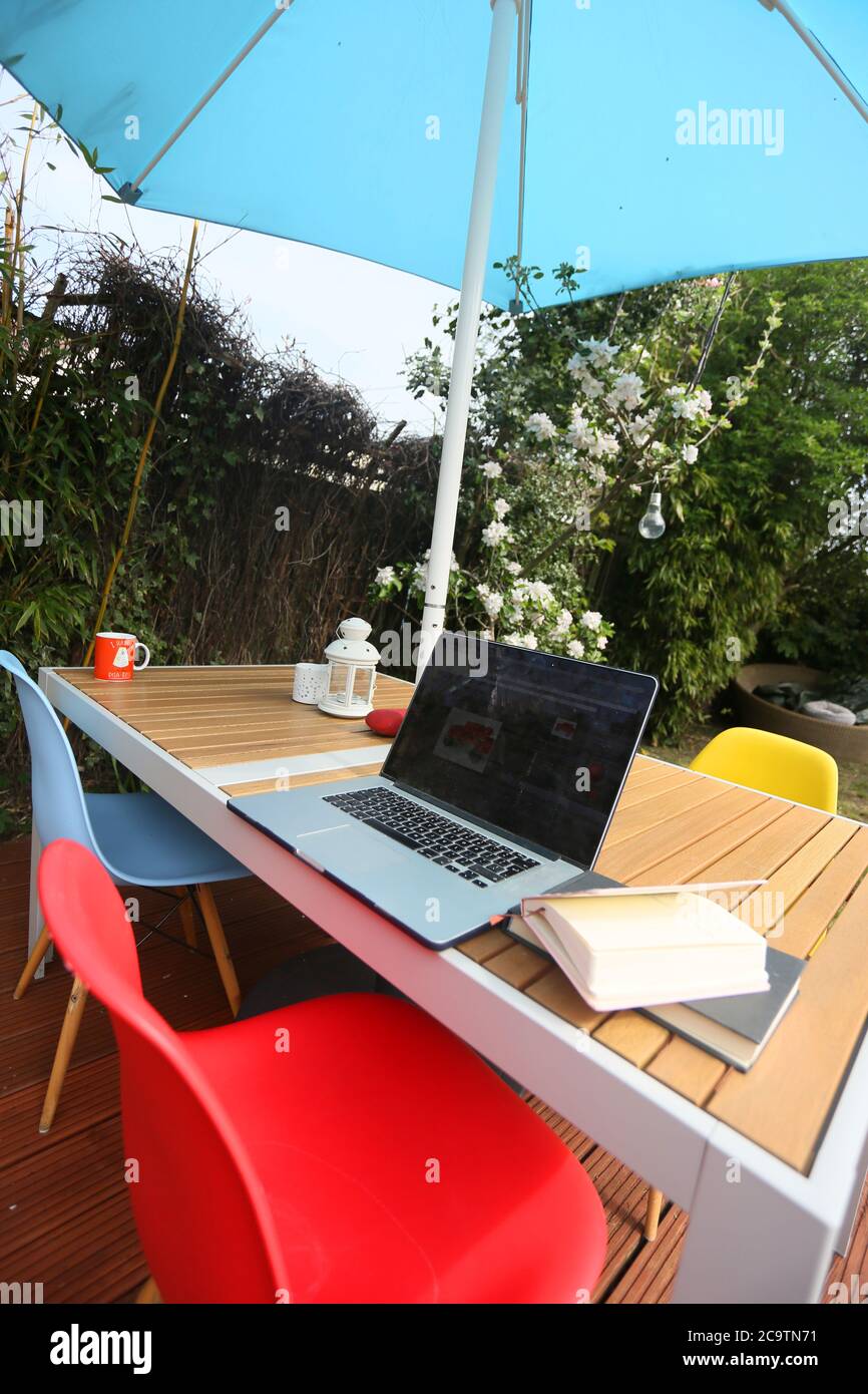 working from home on a modern teak deck and table Stock Photo - Alamy