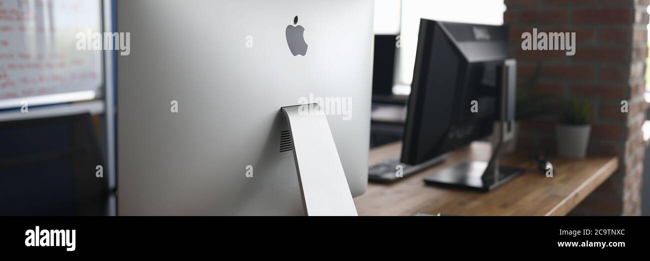 Apple Imac pc against empty office background Stock Photo - Alamy