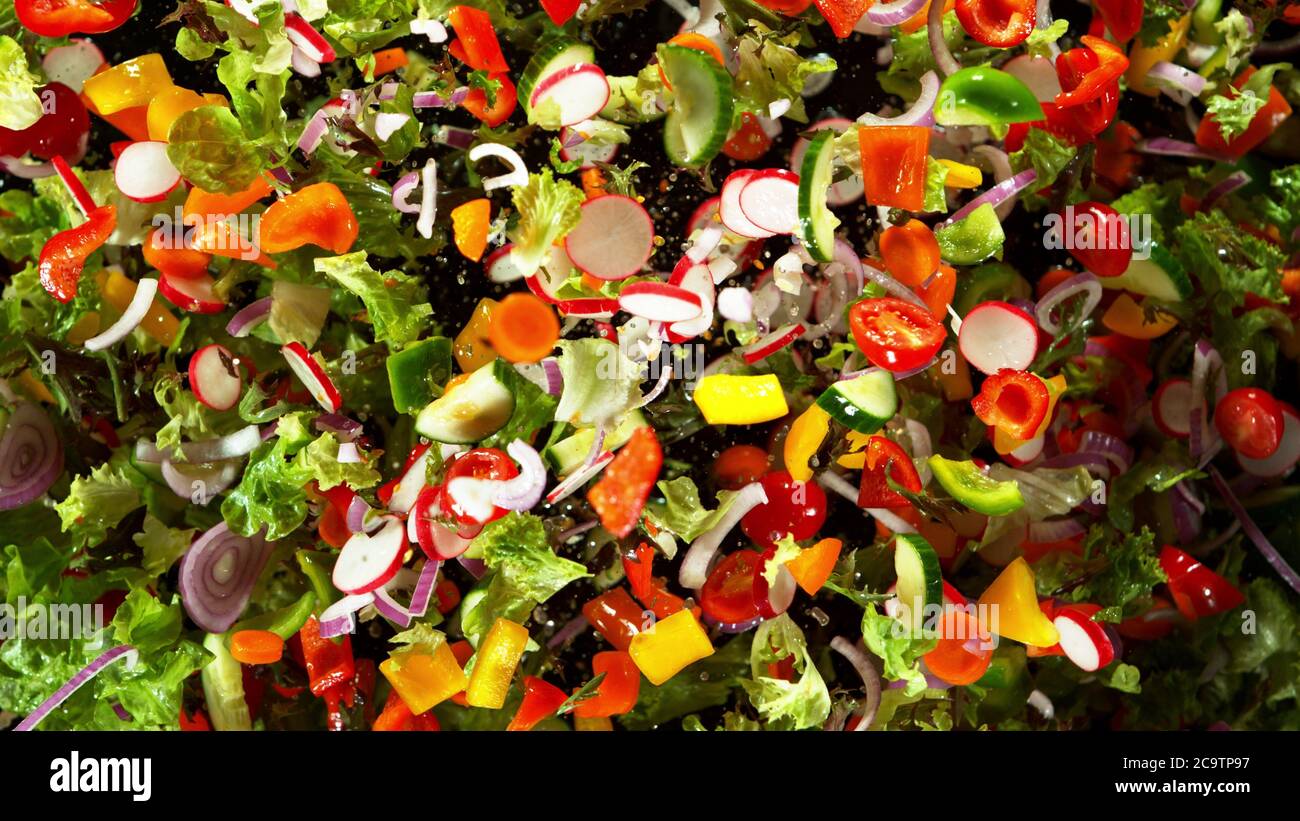 Freeze motion of flying fresh vegetable mix, isolated on black ...