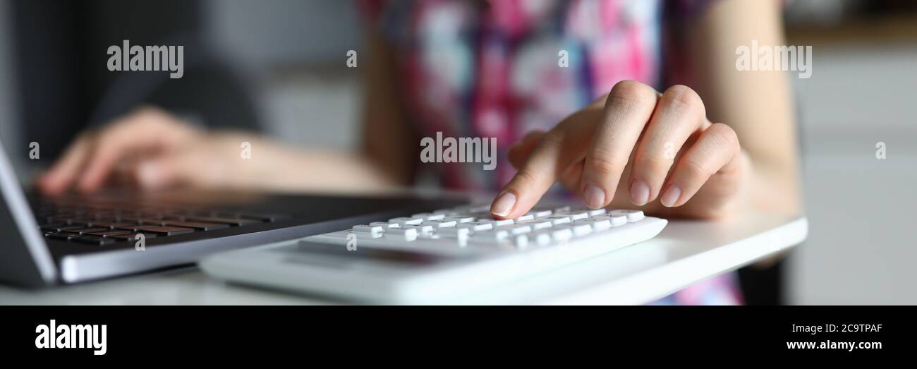 Female hand push button on white calculator closeup Stock Photo - Alamy