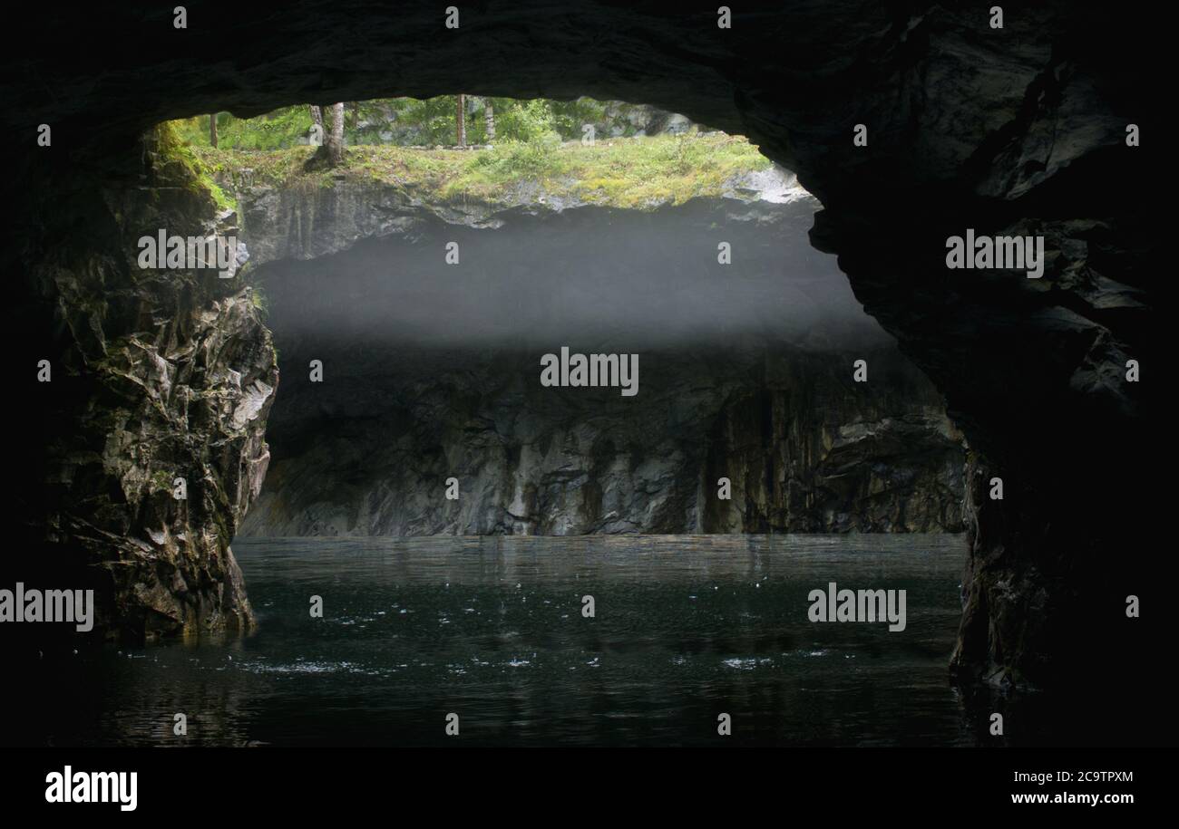 View from inside a flooded cave on a marble slope during fog Stock ...