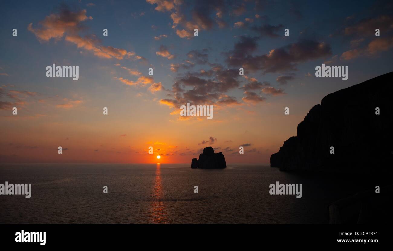 the sunsets behind the faraglione of the sugar loaf, a limestone ...