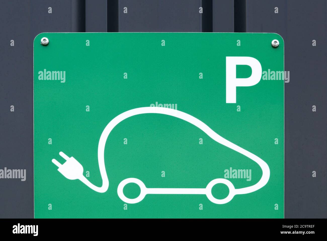 Electric car charging and parking sign on a wall Stock Photo - Alamy