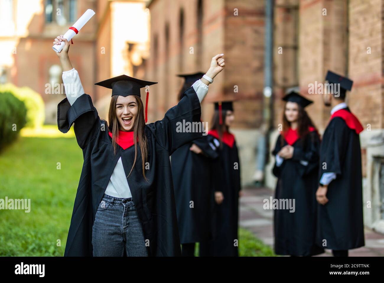 Group of graduate students holding their diploma after graduation Stock ...