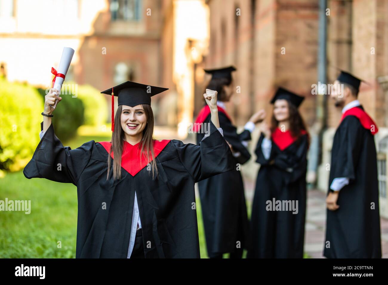 Group of graduate students holding their diploma after graduation Stock ...