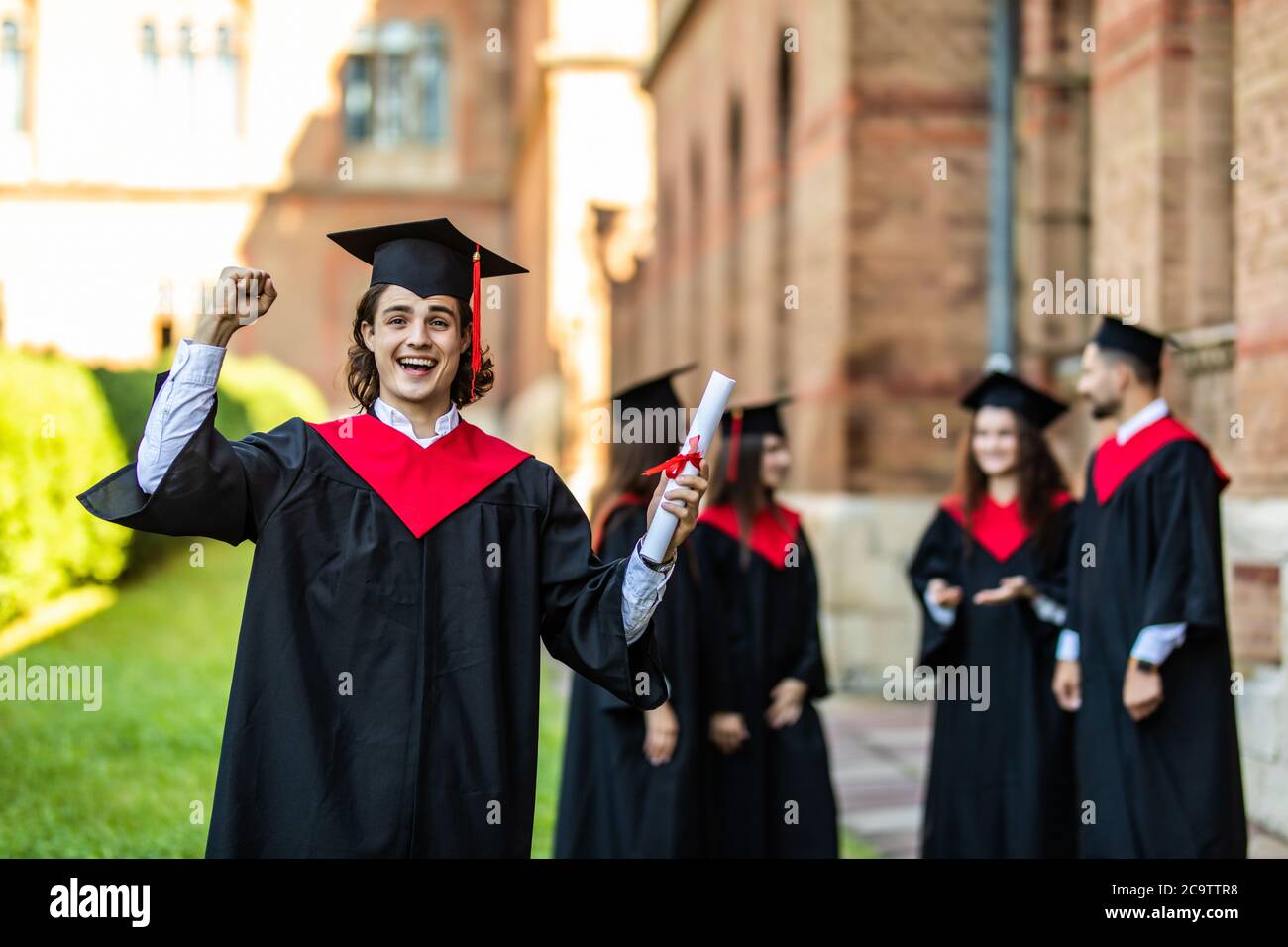 graduation man in front of a group of graduation students Stock Photo ...