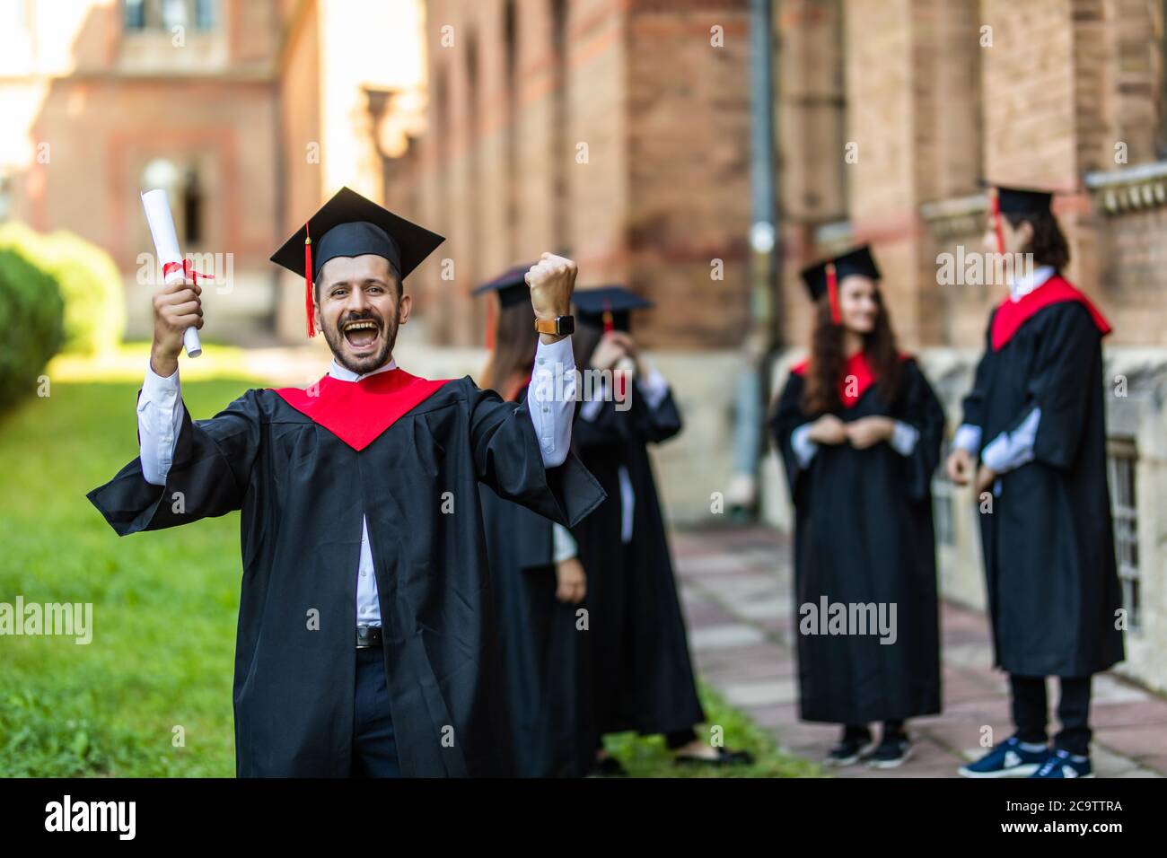 graduation man in front of a group of graduation students Stock Photo ...