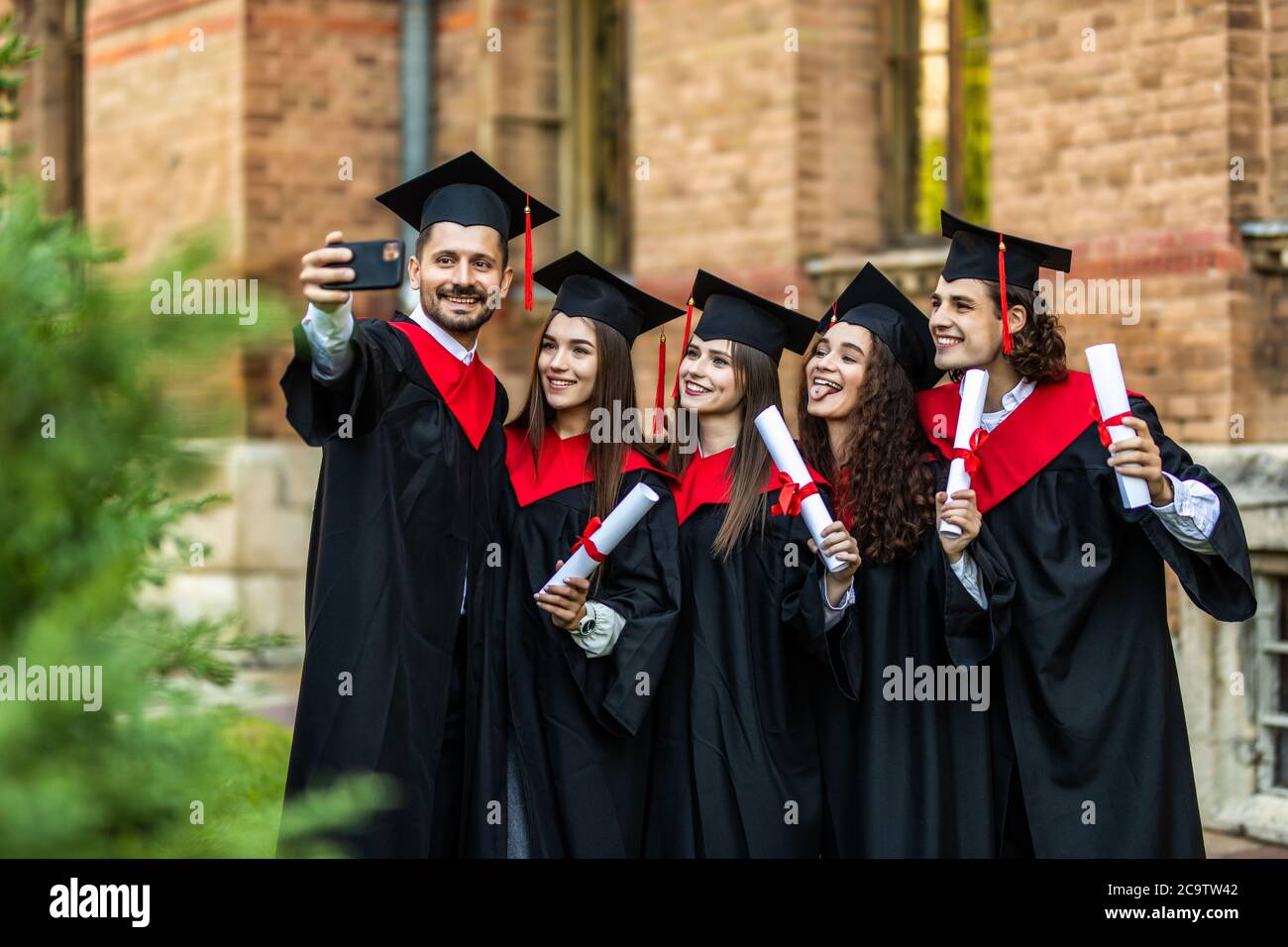 Four university graduates smiling hi-res stock photography and images ...