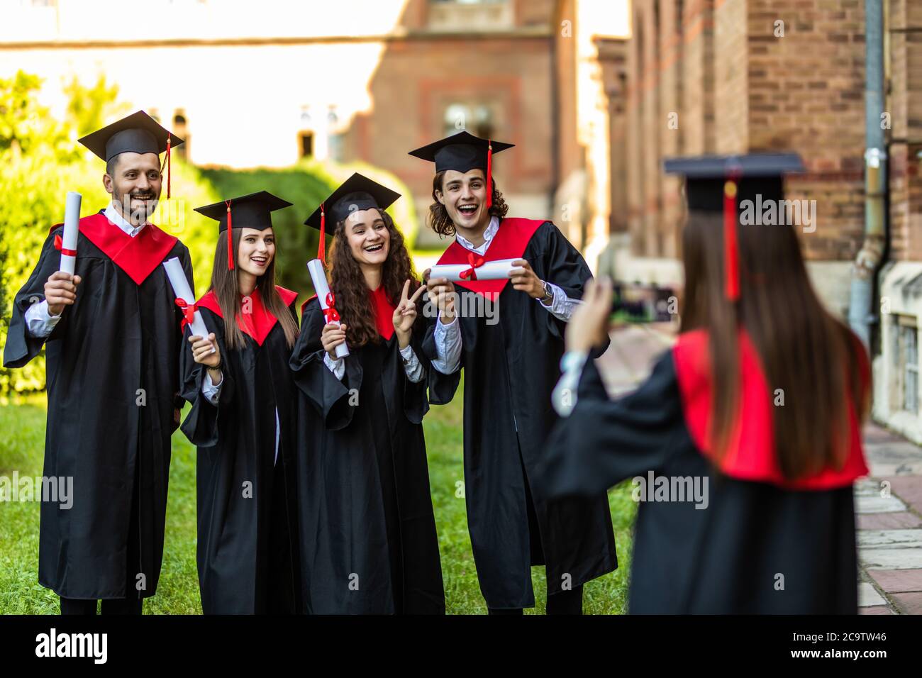 Graduation students take picture on the camera in front of University ...