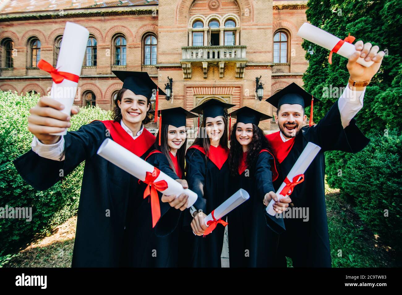 Graduates embrace, enjoy and look forward on the graduation ceremony ...