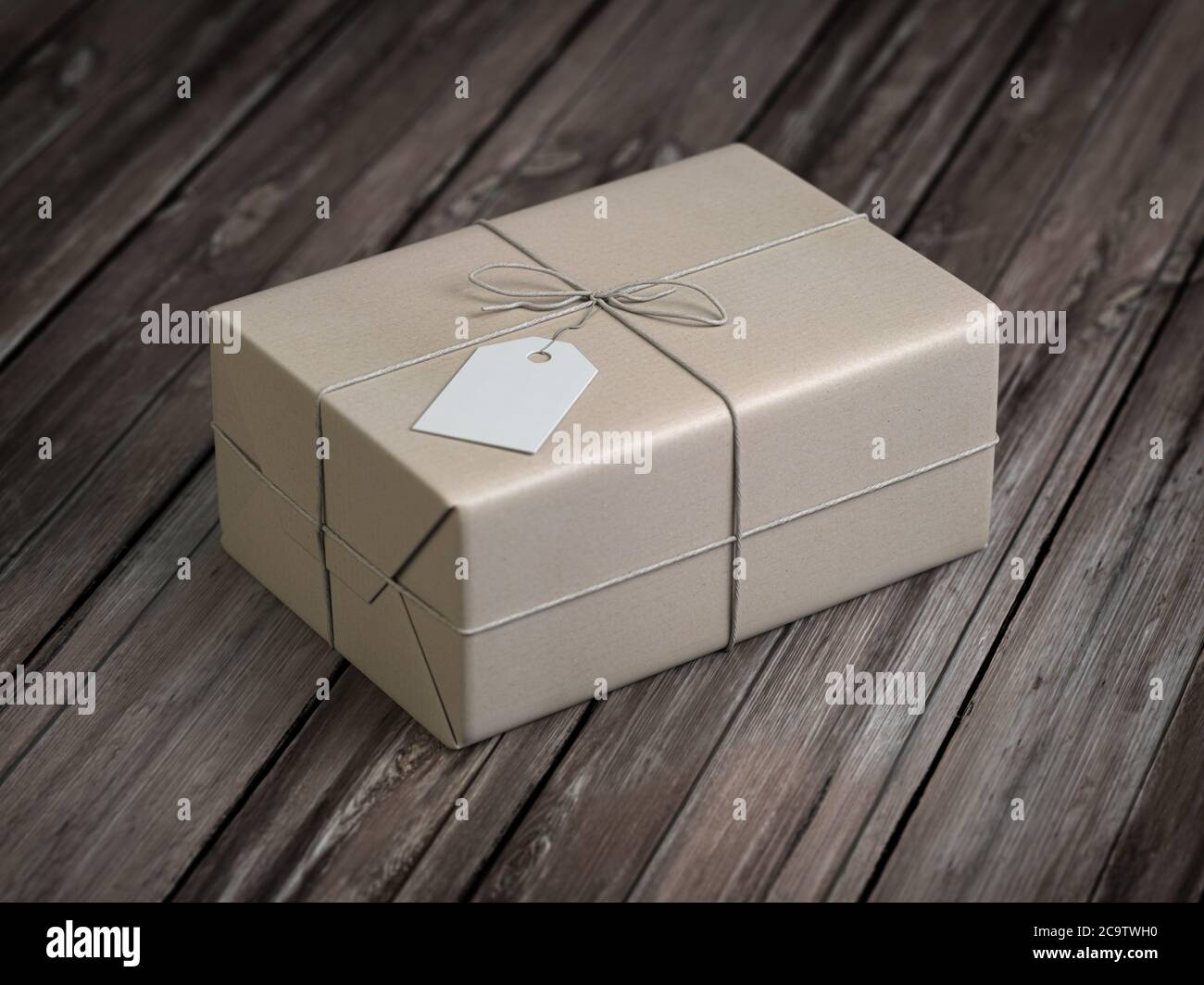 Craft paper gift box with empty label on wooden table. Delivery ...