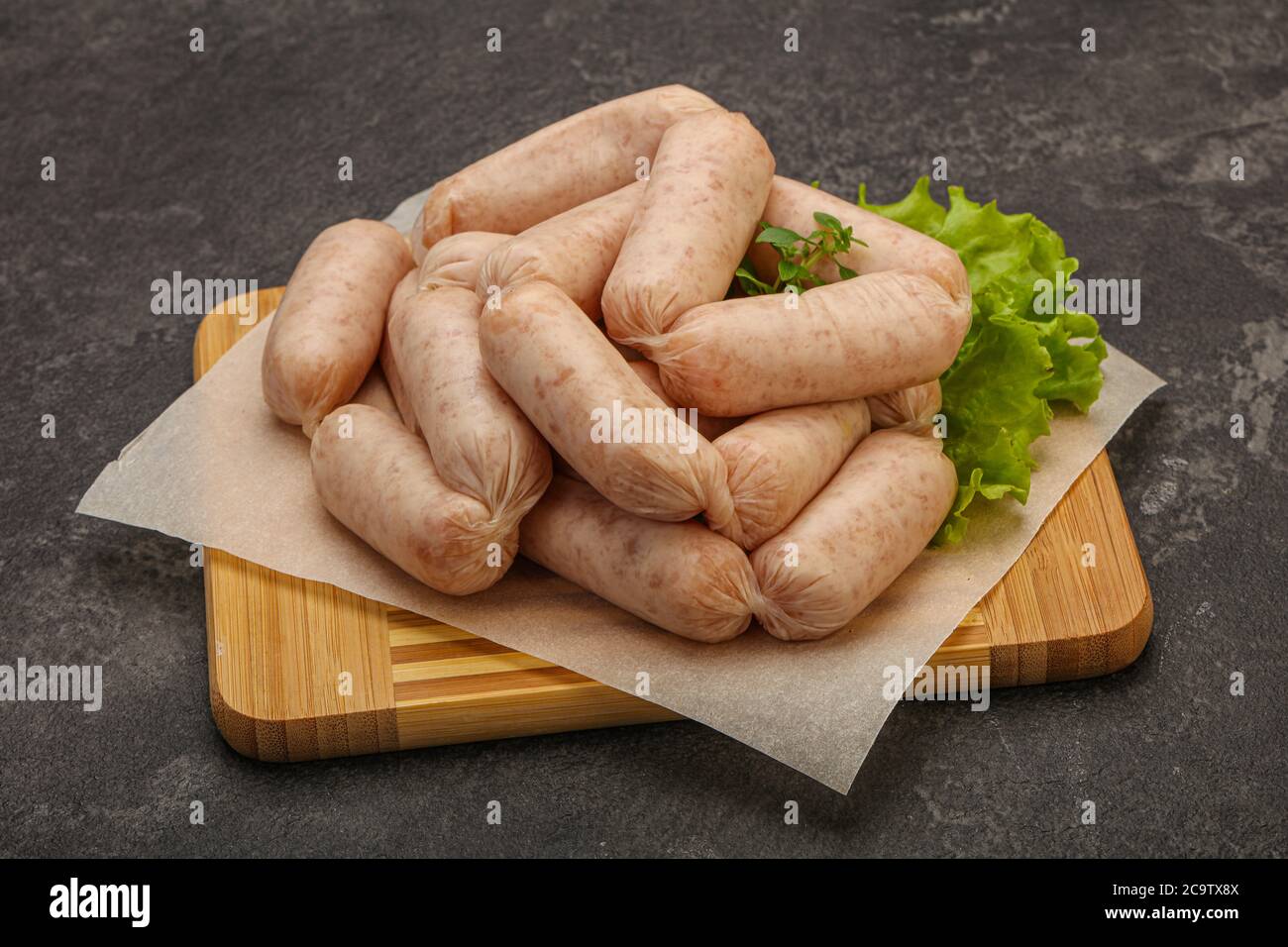Raw natural chicken baby sausages for roast Stock Photo - Alamy