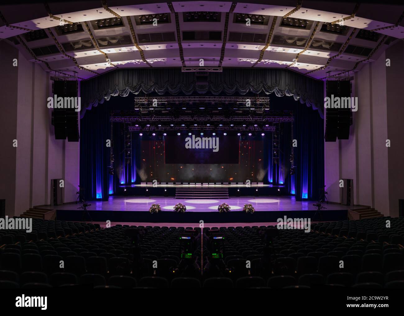 An empty stage of the theater, lit by spotlights and smoke before the ...