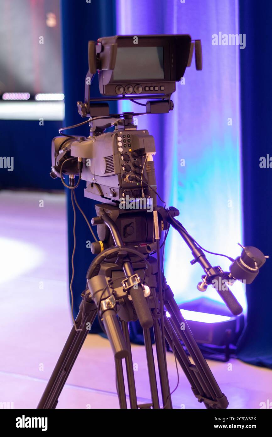 Filming a concert on a television camera on a tripod and crane. Theater ...