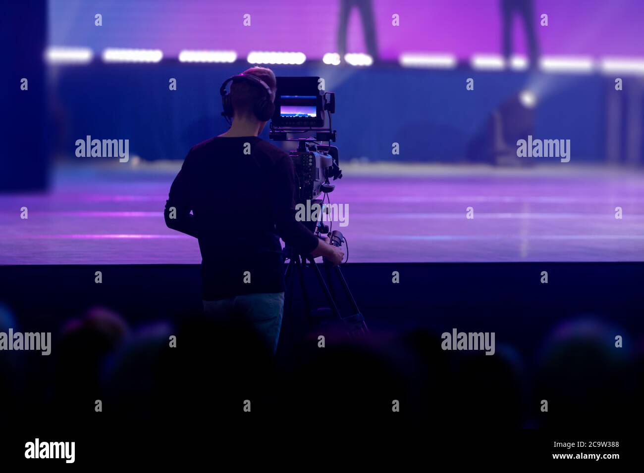 Filming a concert on a television camera on a tripod and crane. Theater ...
