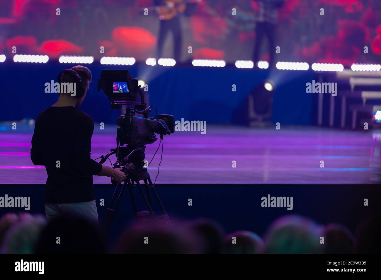 Filming a concert on a television camera on a tripod and crane. Theater ...
