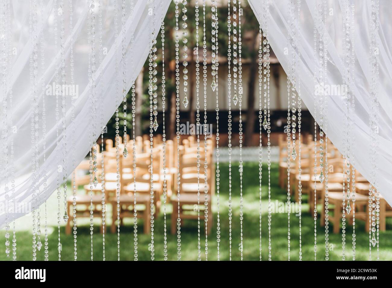 Wedding arch. Preparing for the ceremony in the background wooden ...