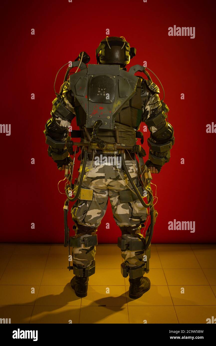 Actor man in a military helmet, mask and uniform with a gauss rifle in ...